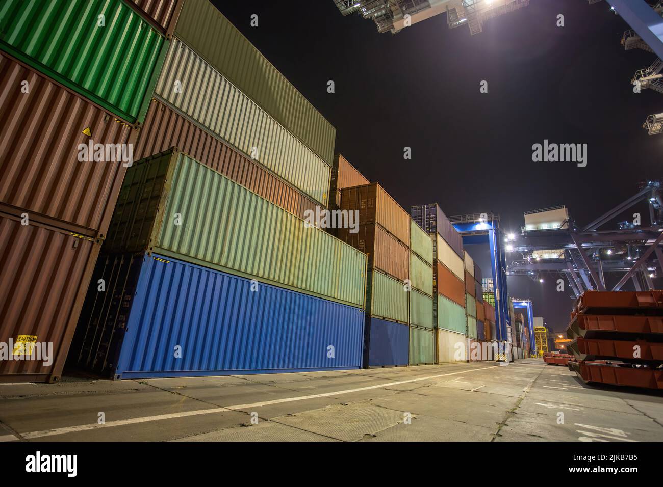 operation of container terminal at night. Unloading container ship at ...