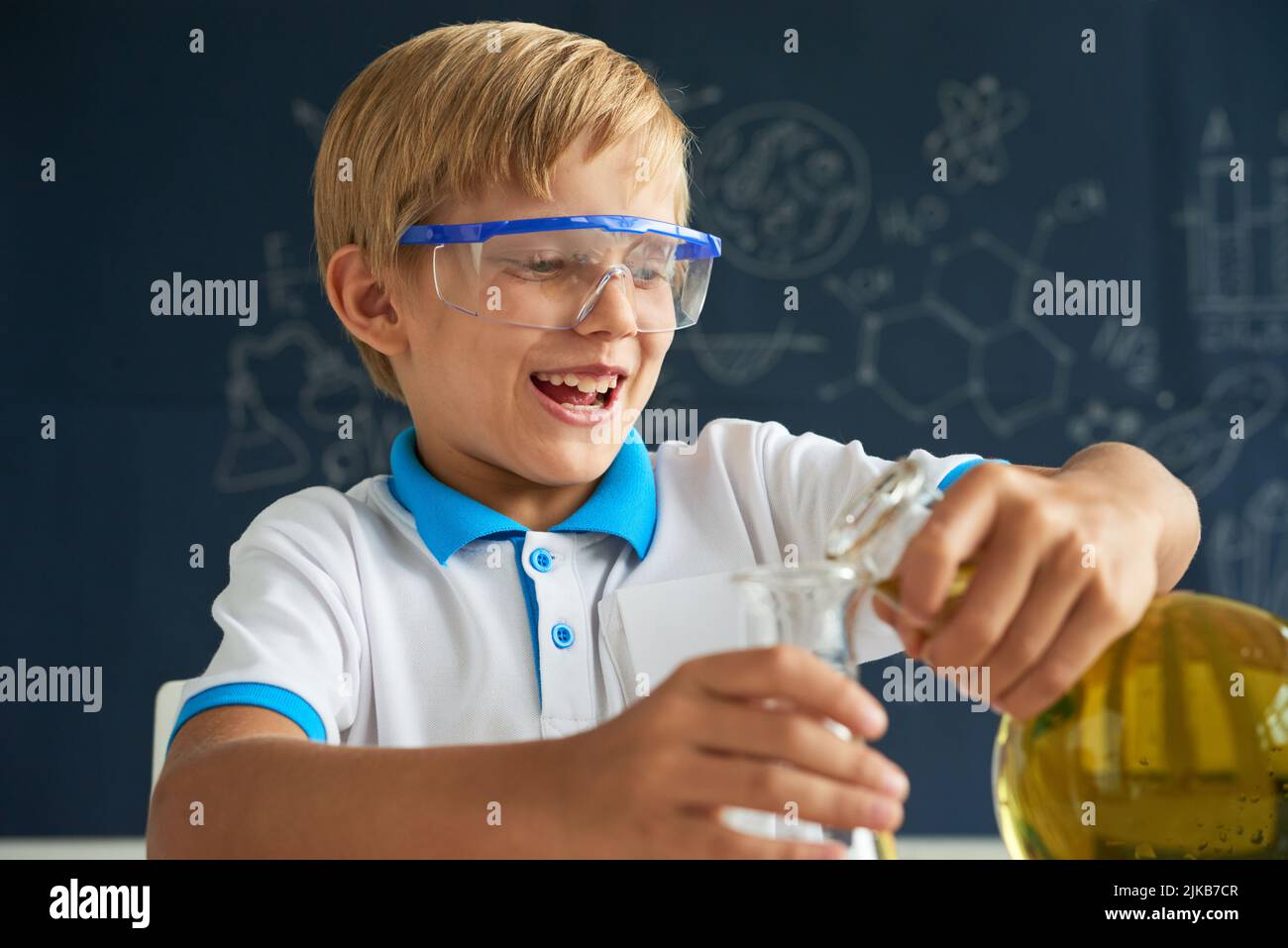 Happy school kid playing with reagents in laboratory Stock Photo - Alamy