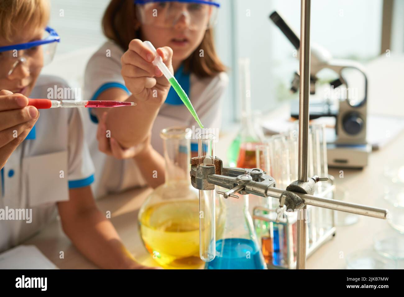 Kids mixing reagents in test-tube at chemistry class Stock Photo - Alamy