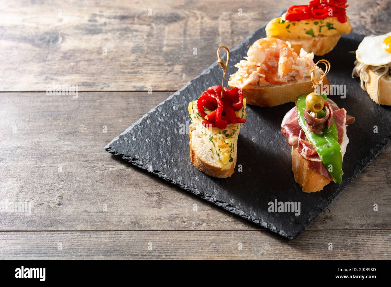 Assortment of Spanish pintxos on wooden table Stock Photo - Alamy