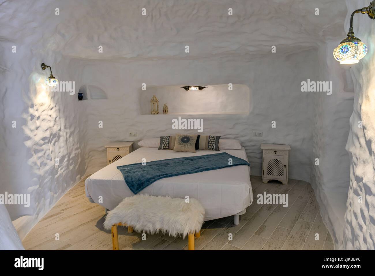 Bedroom inside a troglodyte cave for rural tourism Stock Photo - Alamy