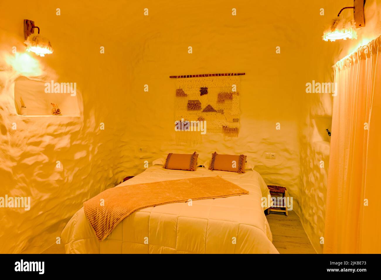 Bedroom inside a troglodyte cave for rural tourism Stock Photo - Alamy