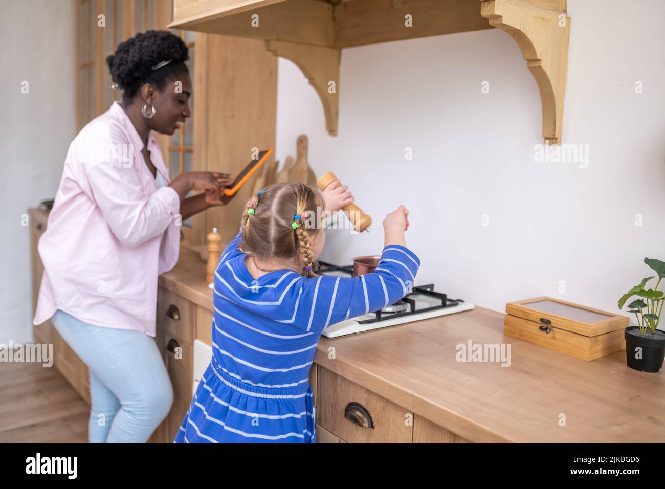 A woman and a girl looking busy while doing some housework Stock Photo ...