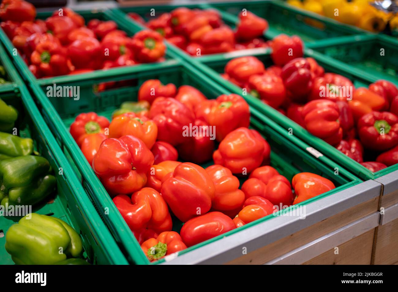 Raw juicy red bell pepper in plastic basket on the shelf in the ...