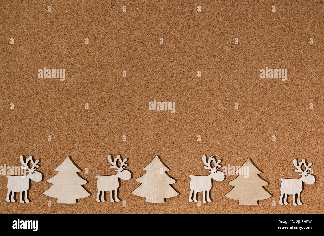 Cork background. Reindeer and Christmas tree copy space border. Place ...