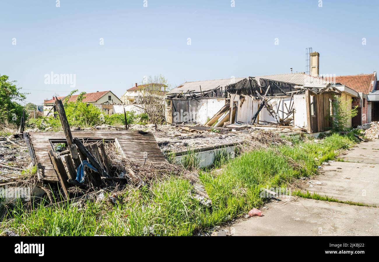 The remains of the burnt house. Ruined and collapsed house burnt and ...