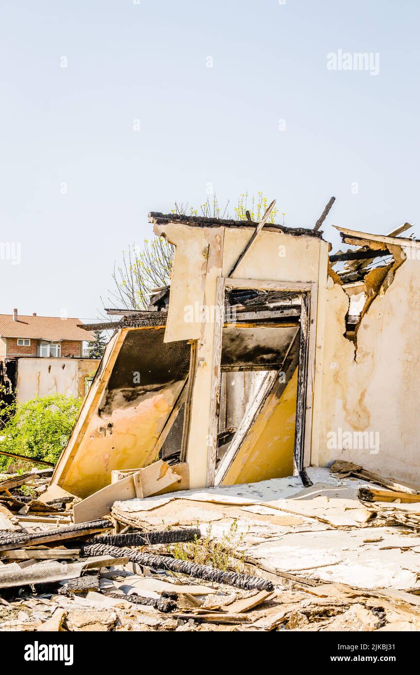 The remains of the burnt house. Ruined and collapsed house burnt and ...