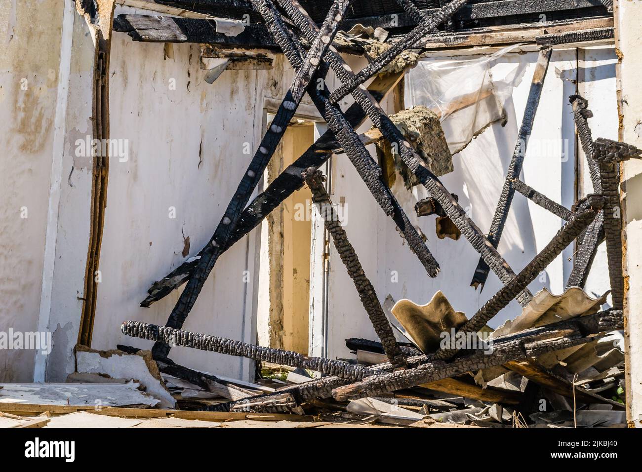 The remains of the burnt house. Ruined and collapsed house burnt and ...