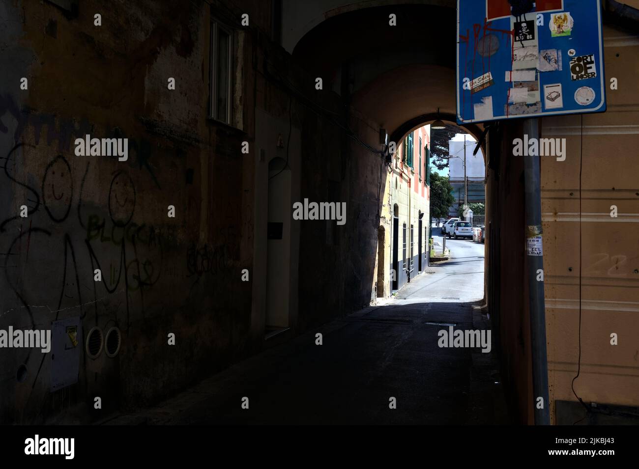 Shady alley under a building Stock Photo - Alamy