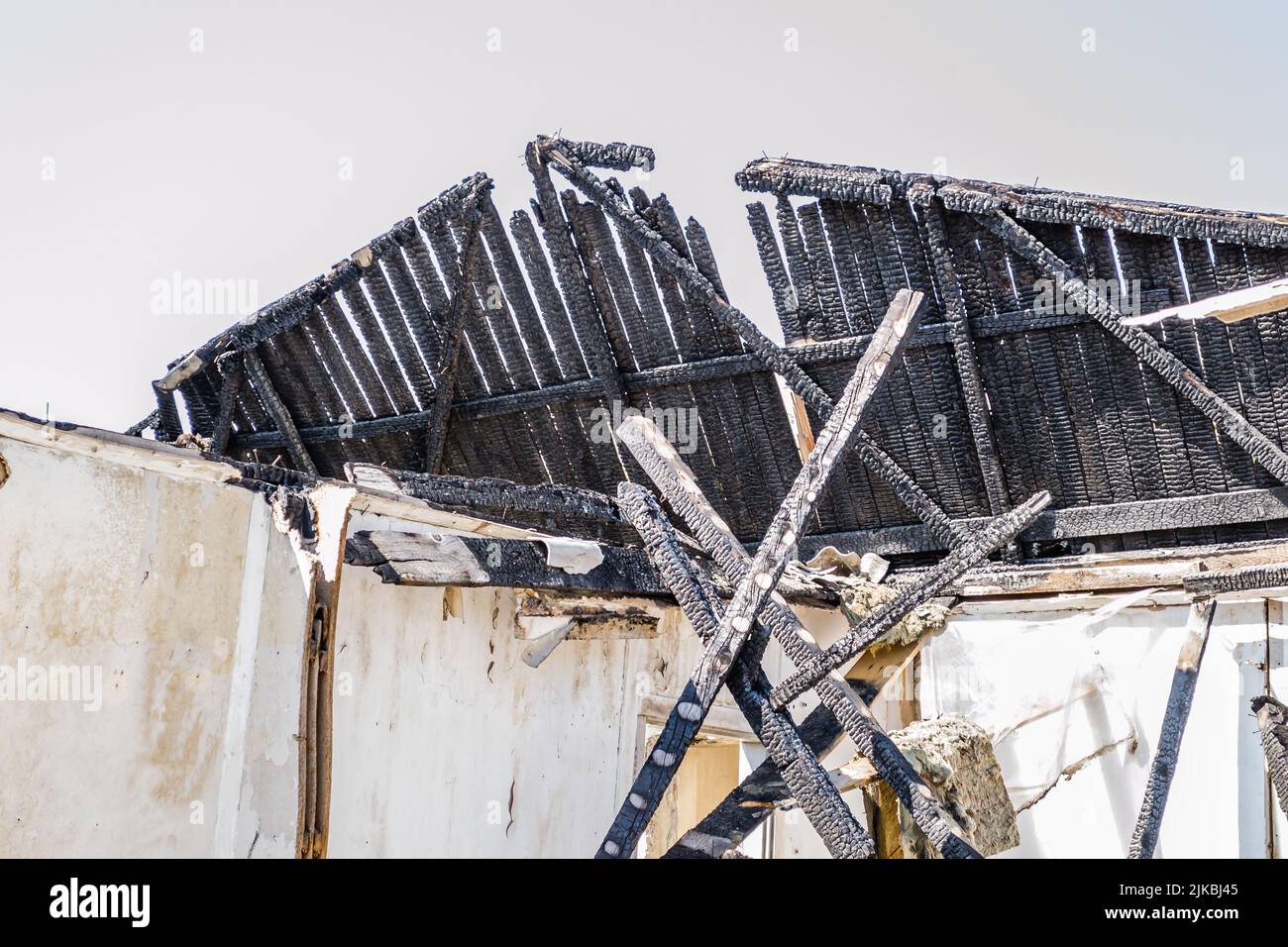 The remains of the burnt house. Ruined and collapsed house burnt and ...