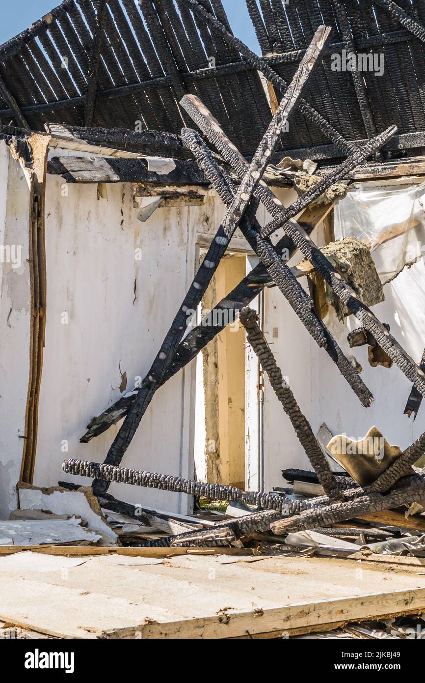 The remains of the burnt house. Ruined and collapsed house burnt and ...