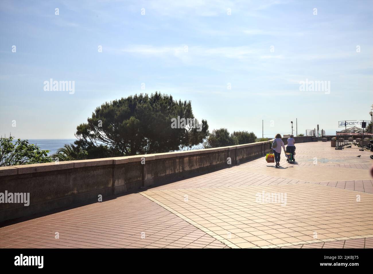 Pavement next to a beach by the seaside on a clear day Stock Photo - Alamy