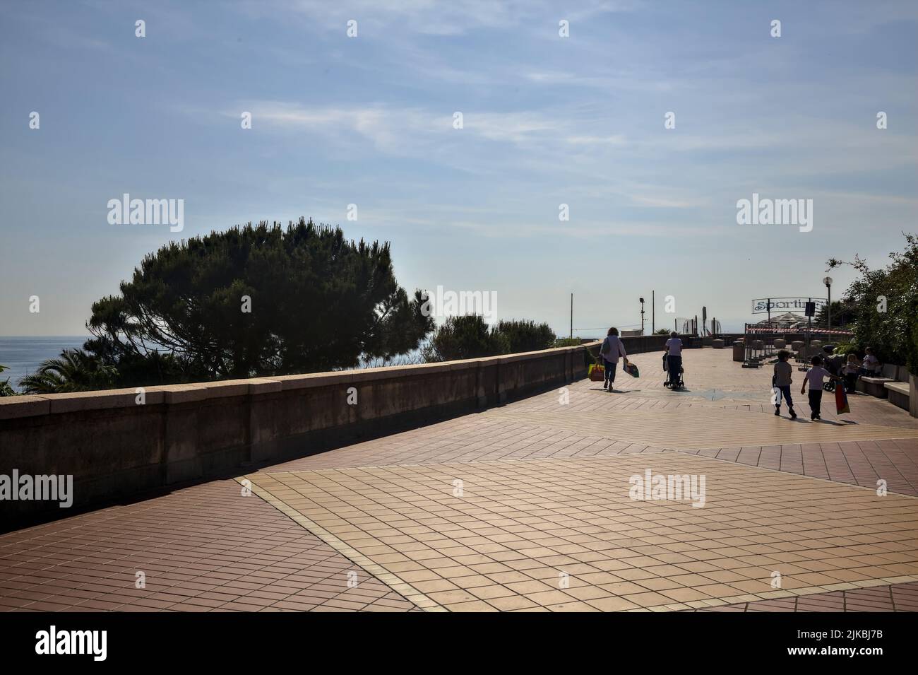 Pavement next to a beach by the seaside on a clear day Stock Photo - Alamy