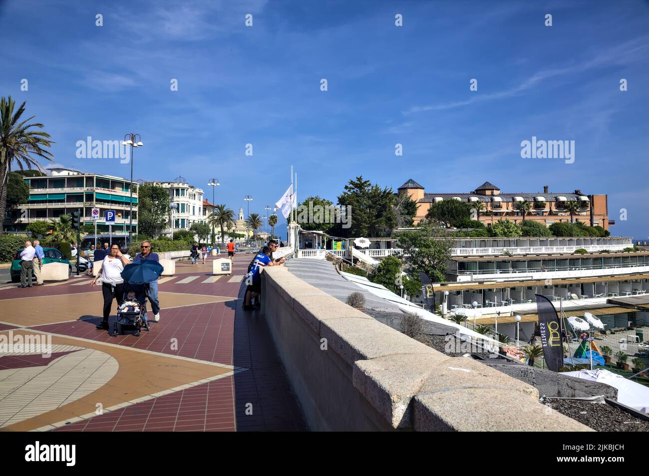Pavement next to a beach by the seaside on a clear day Stock Photo - Alamy