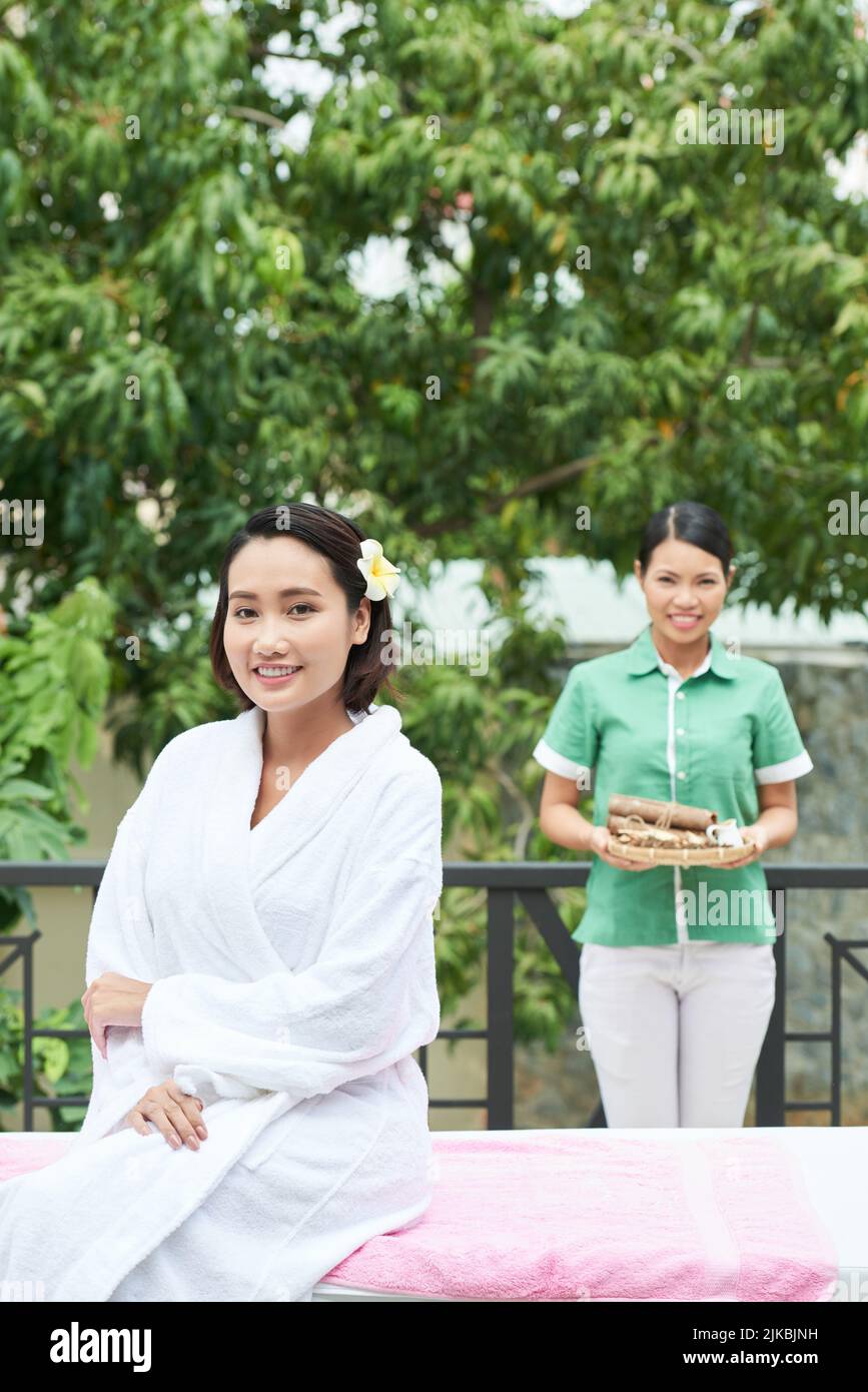 Pretty smiling spa salon client waiting for masseur Stock Photo - Alamy
