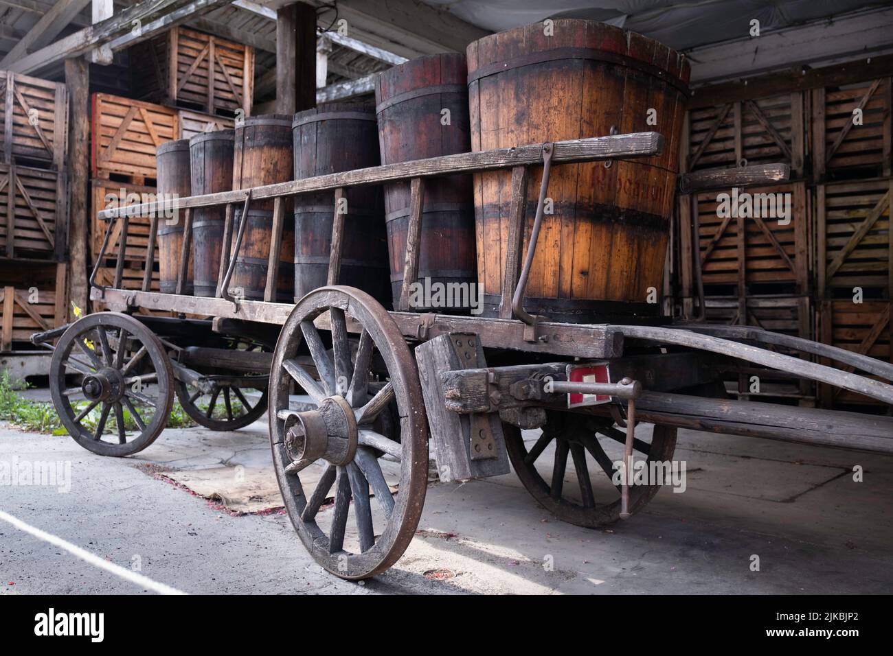 Old wooden wine barrels on a wooden cart in the french town of ...