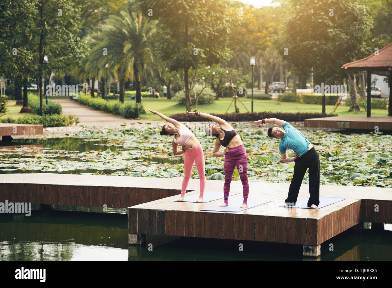 Young Vietnamese people attending outdoor stretching class Stock Photo ...