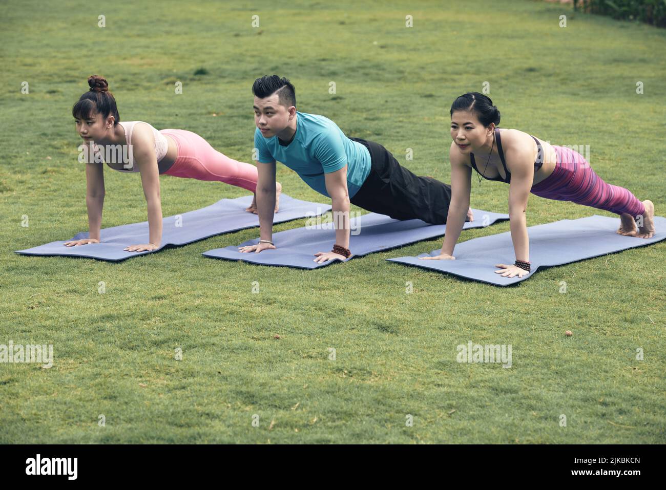 Young Asian people doing plank exercise outdoors Stock Photo - Alamy