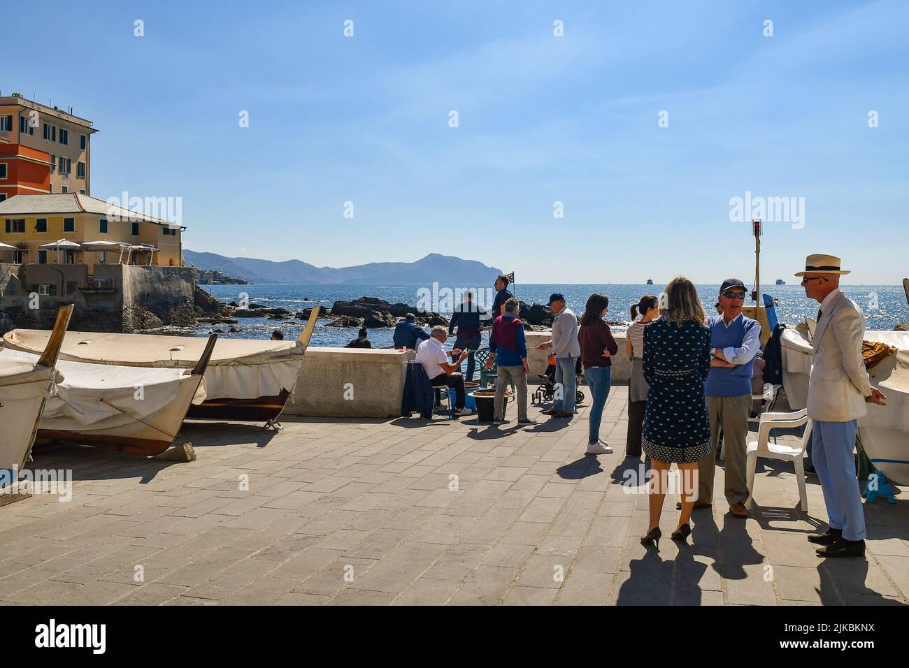 Tourists and fishermen between dry boats on the waterfront of the old ...