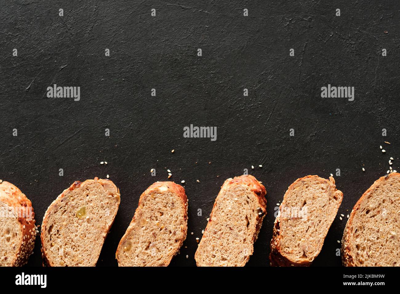 wholegrain bread craft bakery black background Stock Photo - Alamy