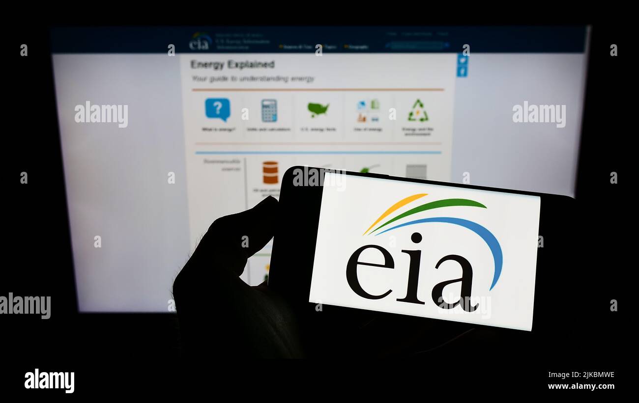 Person holding cellphone with logo of U.S. Energy Information ...