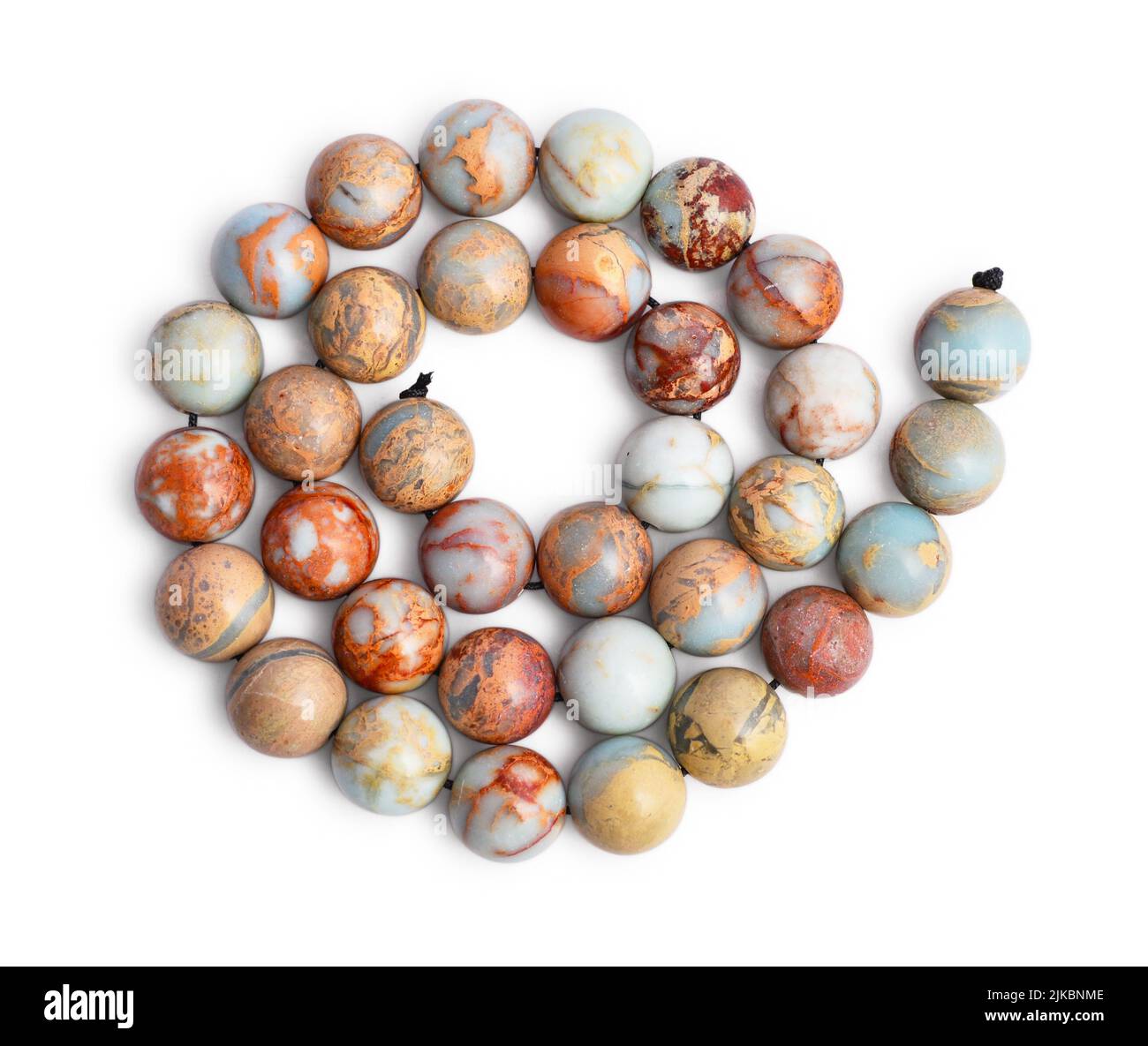 Colorful jasper stone beads isolated on white background top view ...