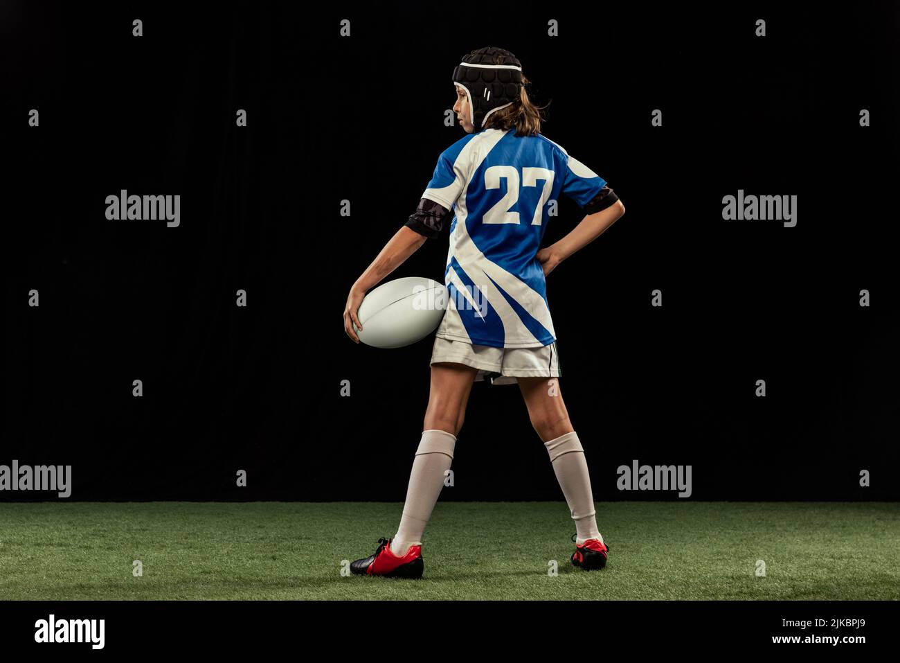 Dynamic portrait of school age boy, junior male rugby player practicing ...