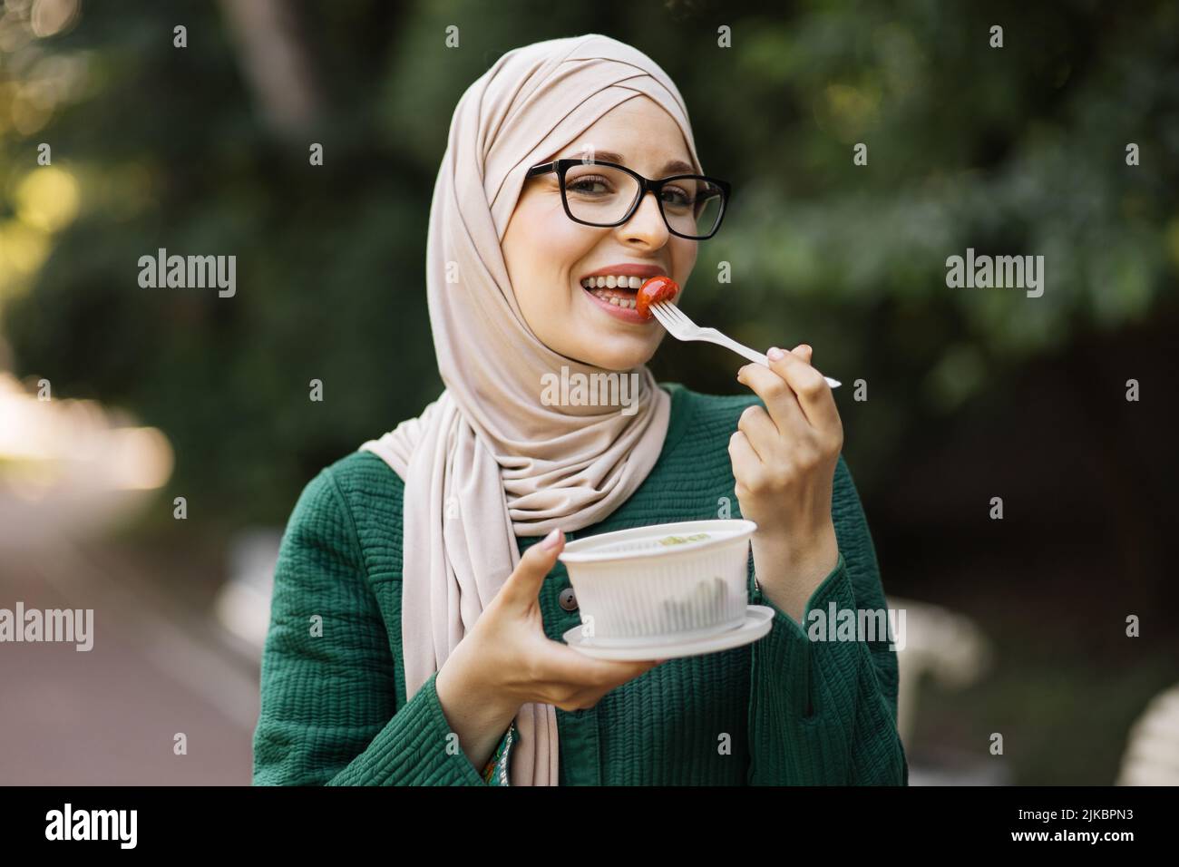 Muslim woman eating salad hi-res stock photography and images - Alamy