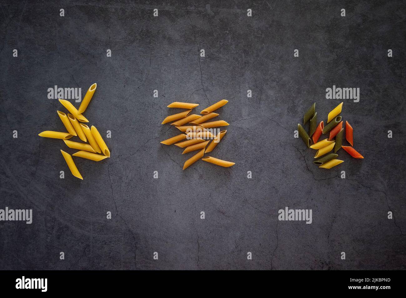 Three types of penne pasta, wholemeal, integrale, tri colore and ...