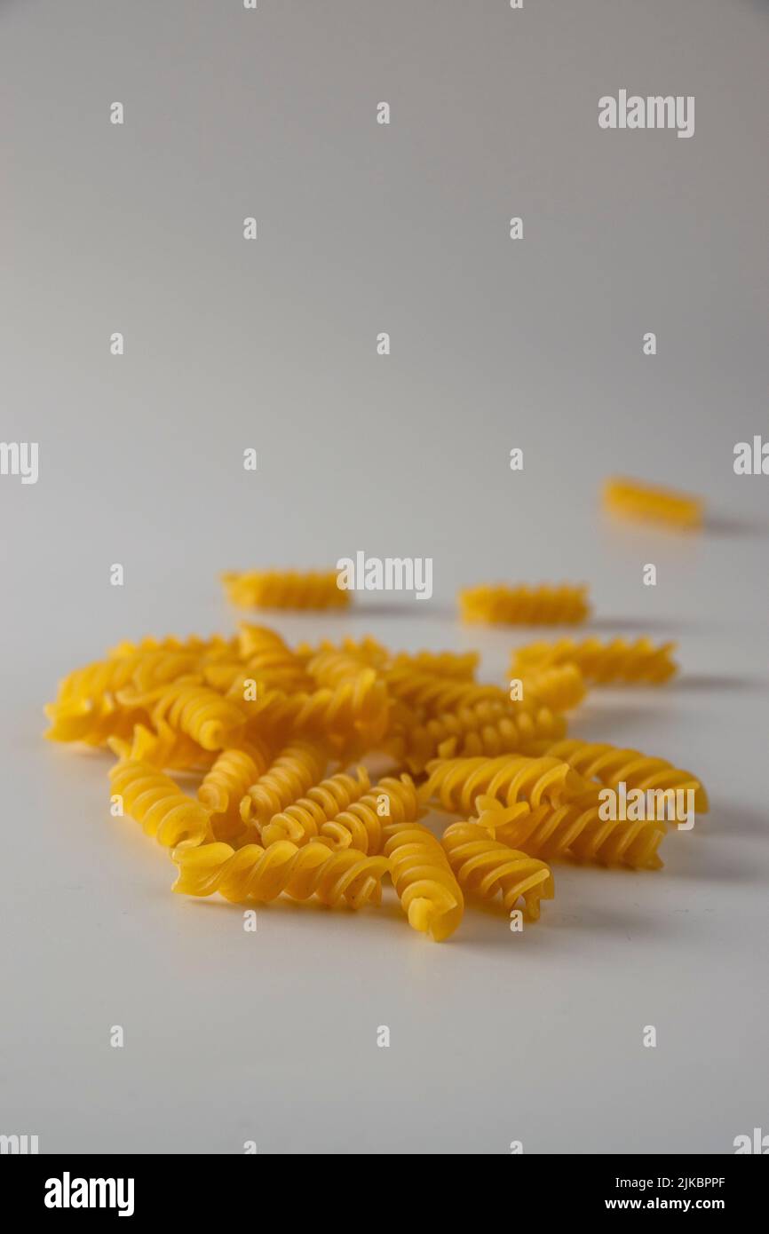 Fusilli italian pasta scattered freely on a white background Stock ...