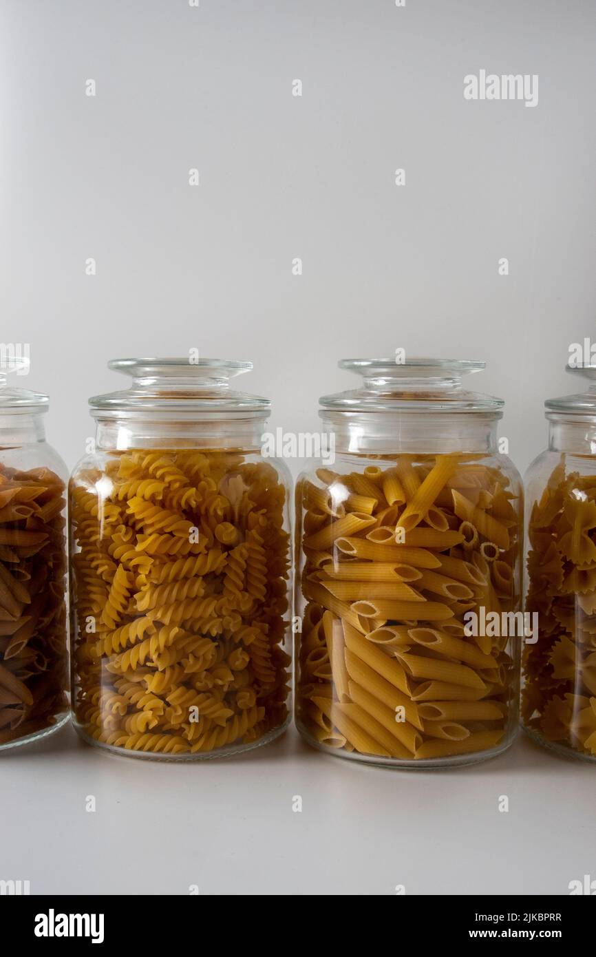 Different types of italian pasta standing next to each other in a glass ...