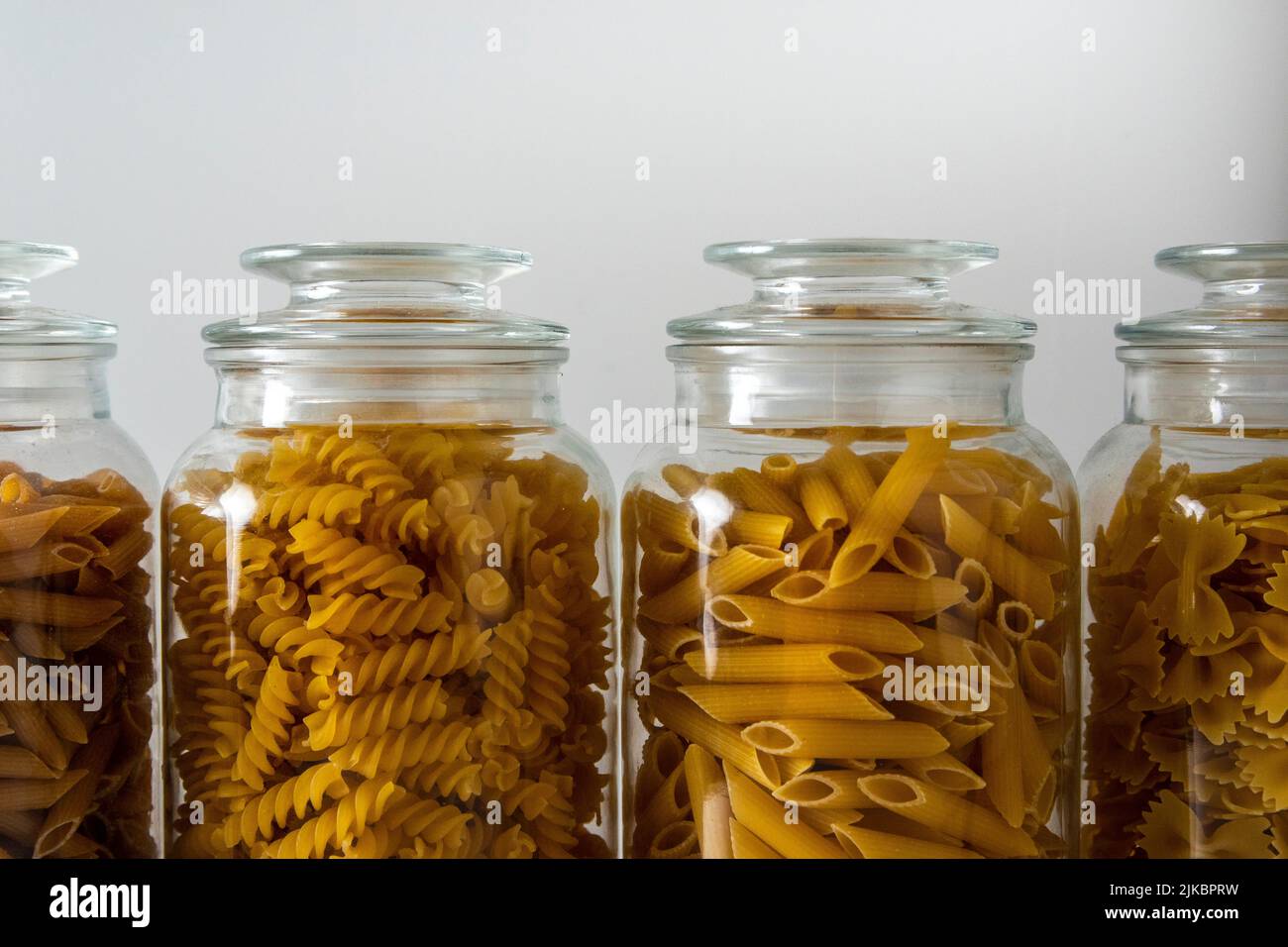 Different types of italian pasta standing next to each other in a glass ...