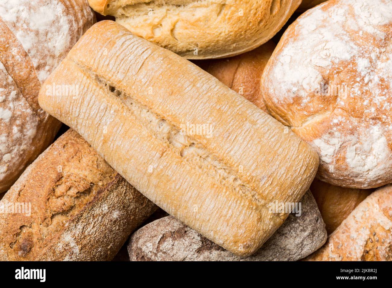 Homemade natural breads. Different kinds of fresh bread as background ...