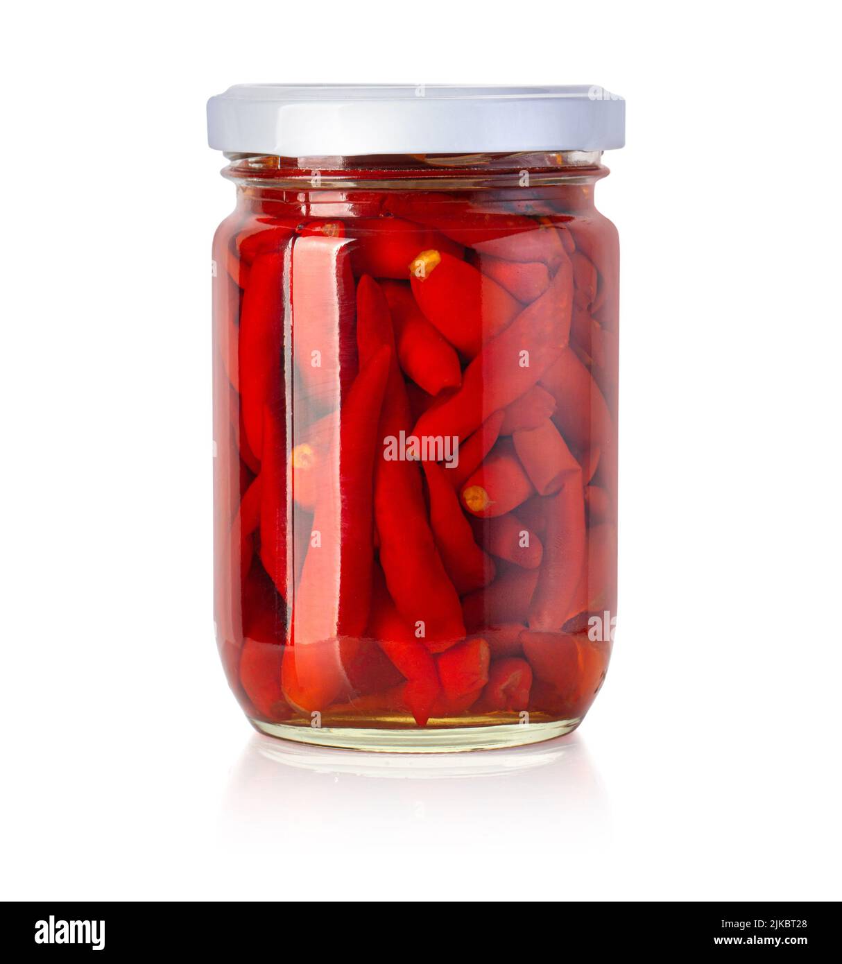 canned red peppers in a glass jar isolated on a white background with ...