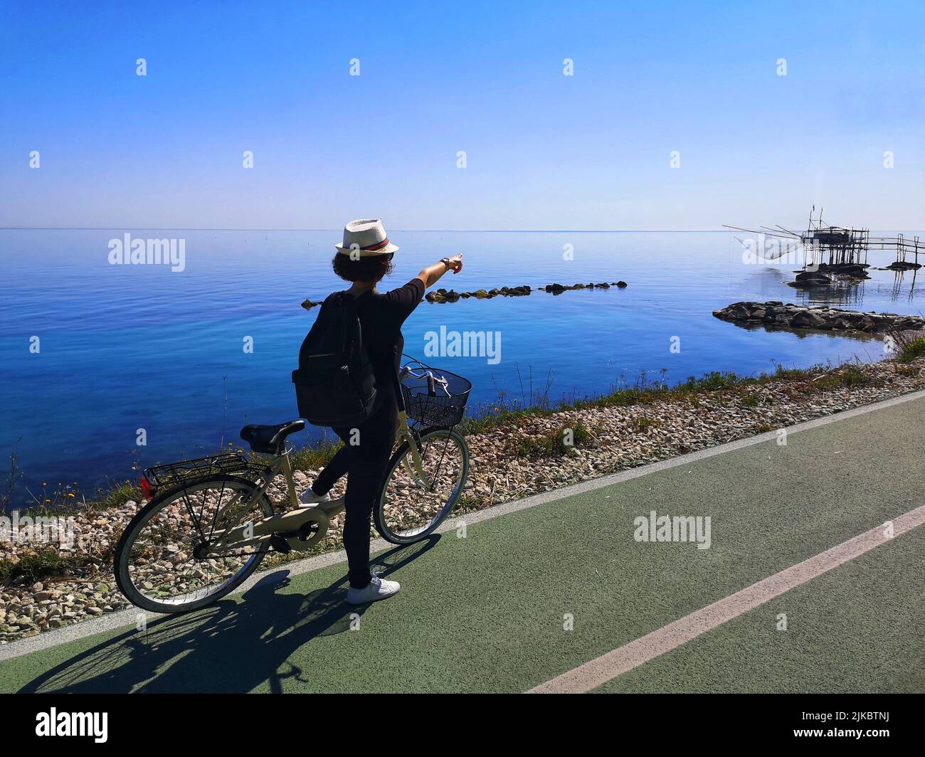 A female with a bike standing on the cycle path of San Vito Chietino ...