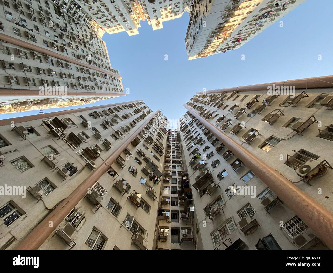 A low-angle shot of residential buildings blocks in Macau in blue sky ...