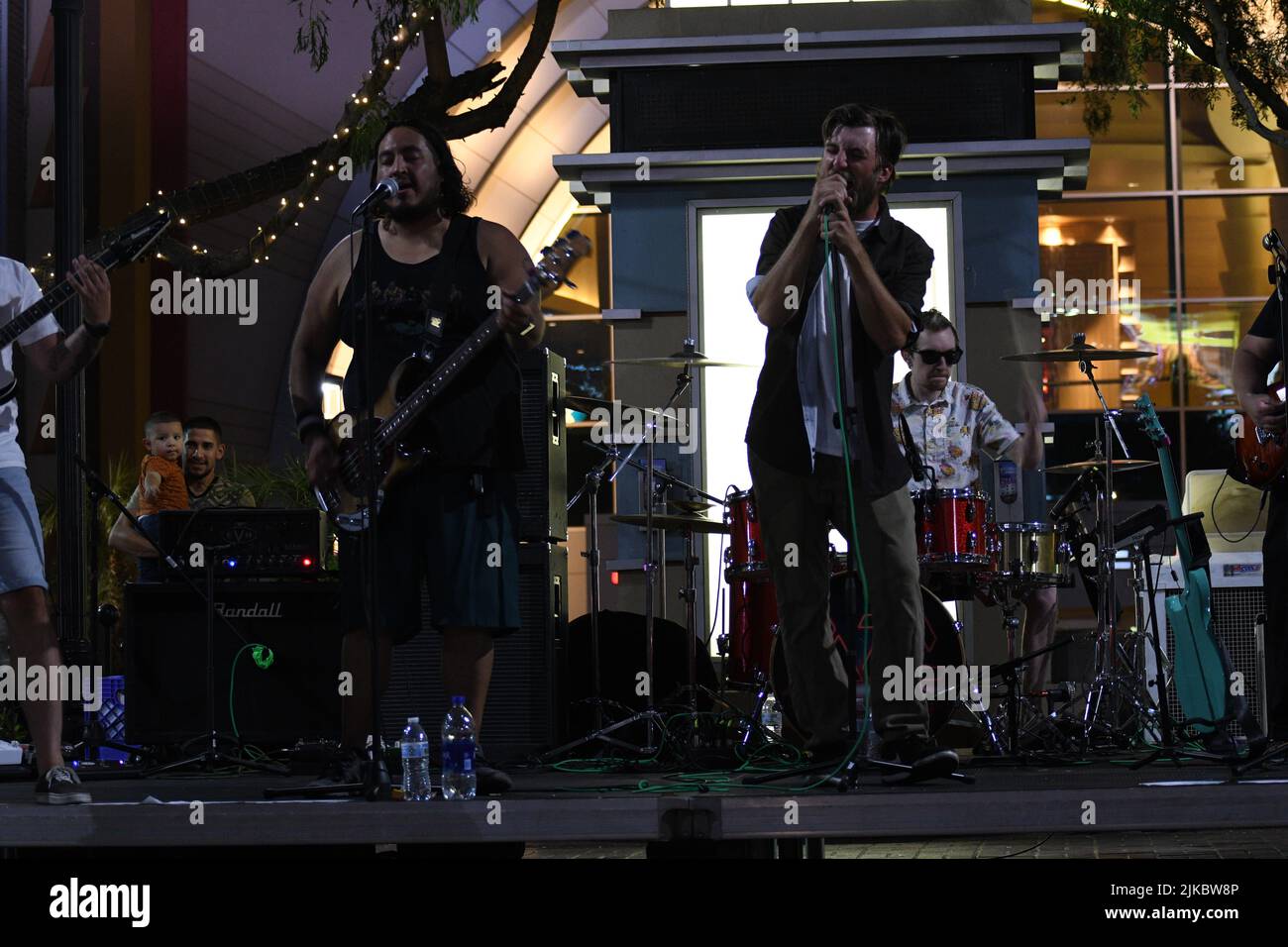A band performing on an outdoor stage Stock Photo - Alamy