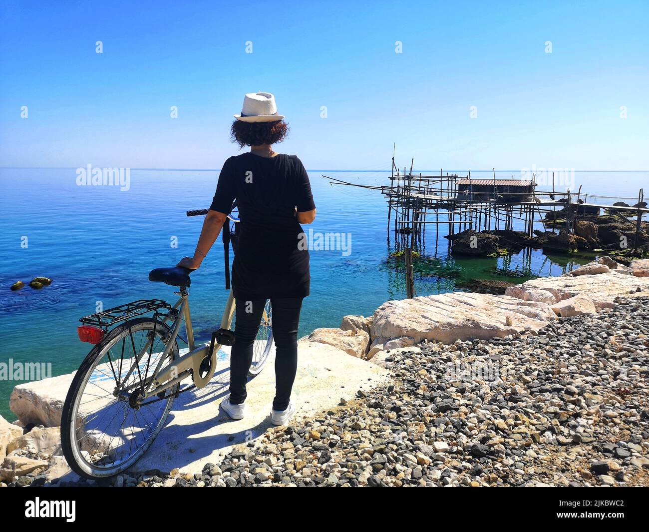 A female with a bike standing on the cycle path of San Vito Chietino ...