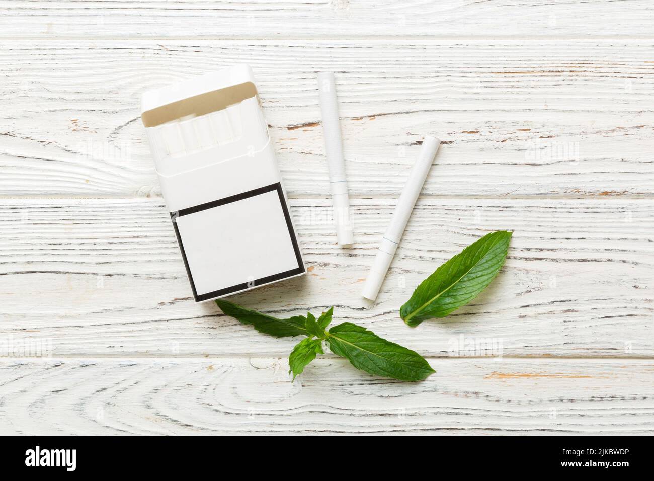 Pack of menthol cigarettes and fresh mint on colored table, Menthol ...