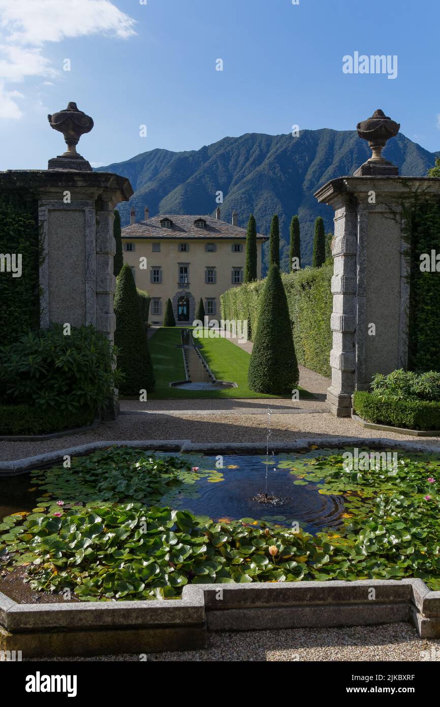 A vertical shot of a small pond in the mountains by the Como lake in ...
