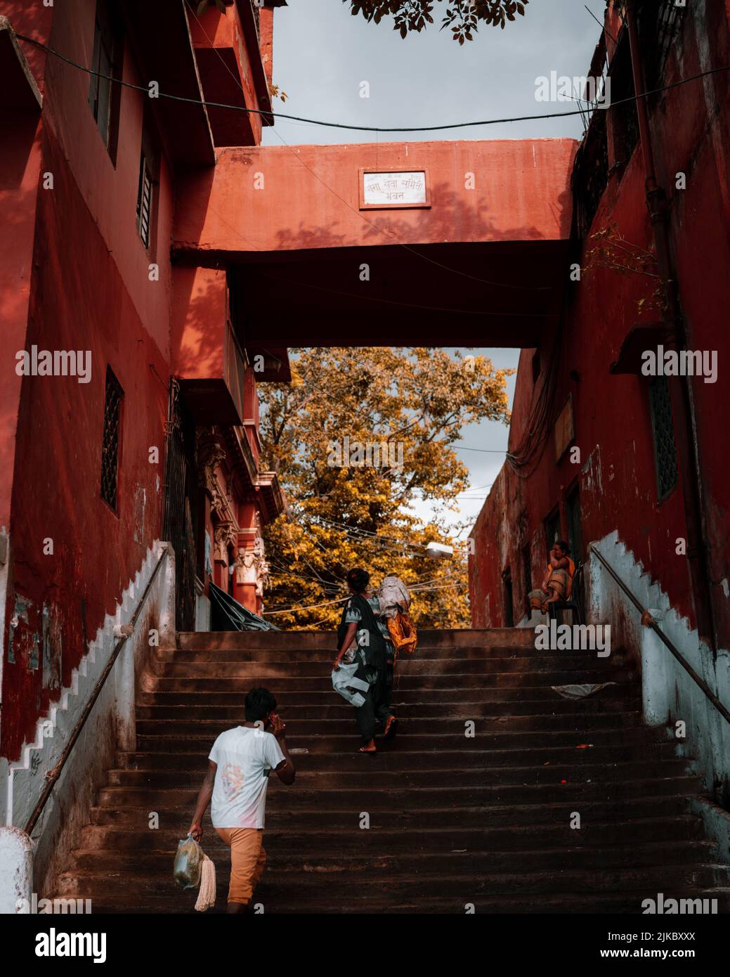 A vertical shot of two people climbing the stairs outdoors Stock Photo ...