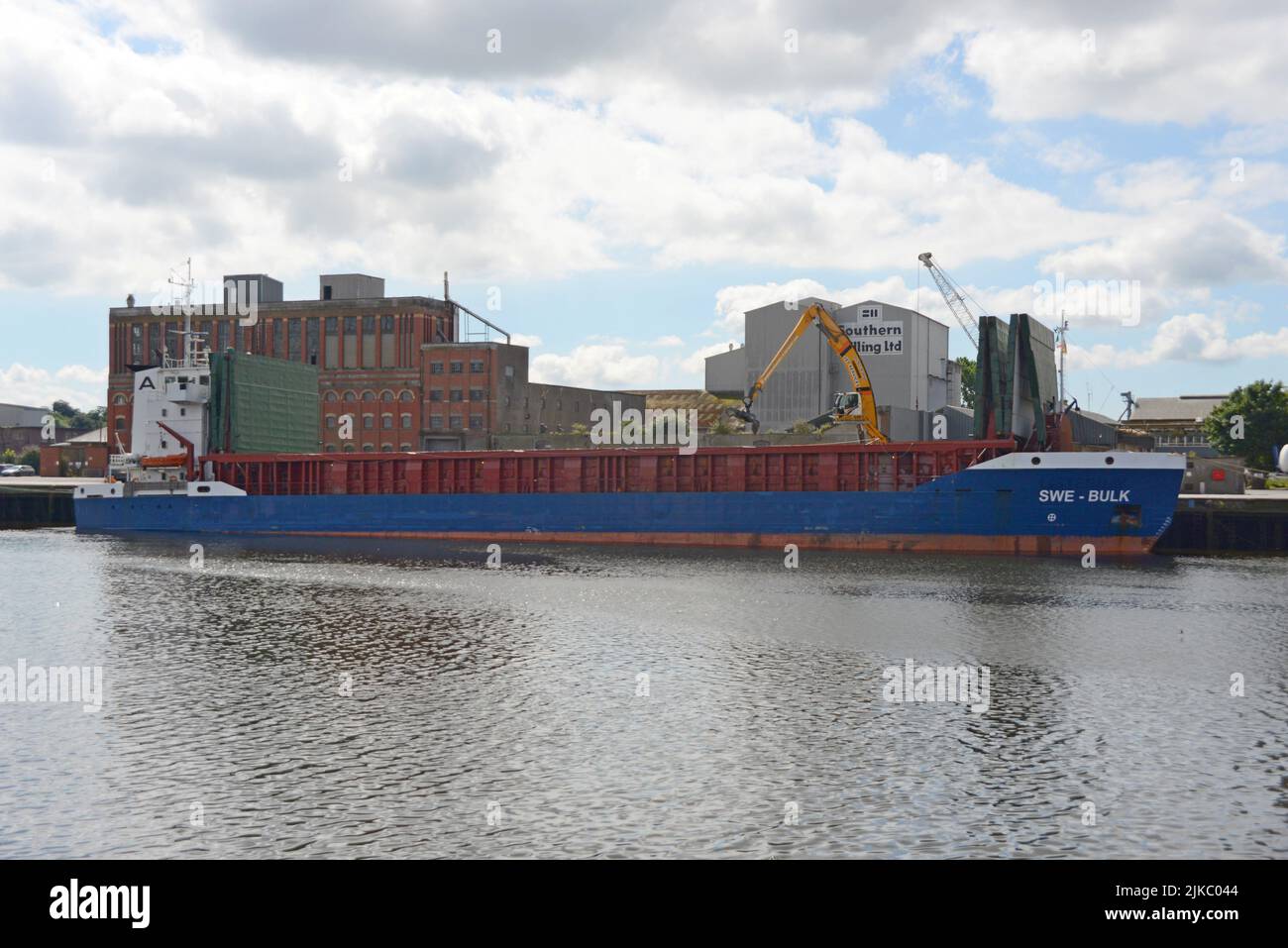 The general cargo ship SWE-BULK loading cargo at the dockside in the ...