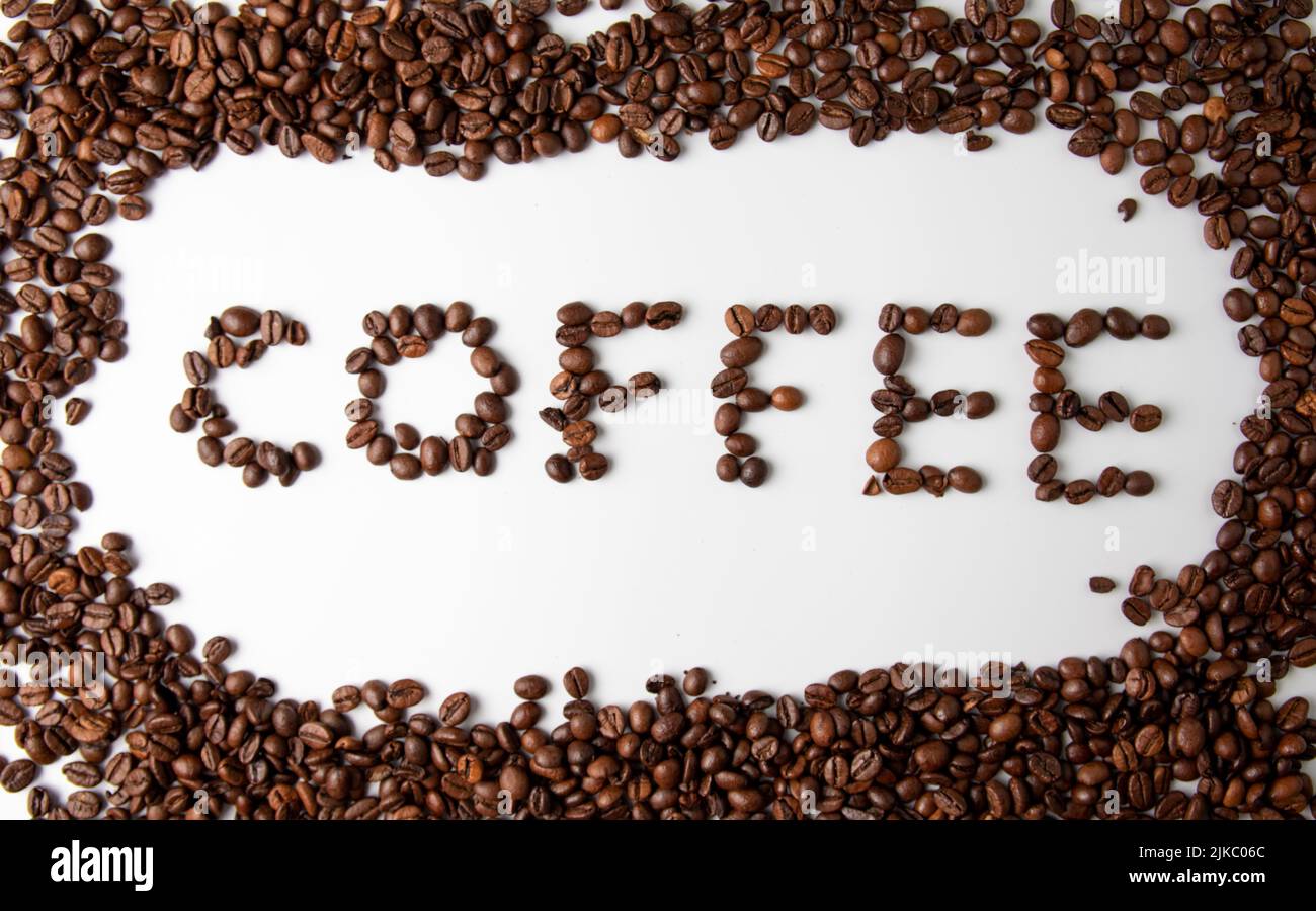 Coffee writing made with coffee beans on a white clear background and ...