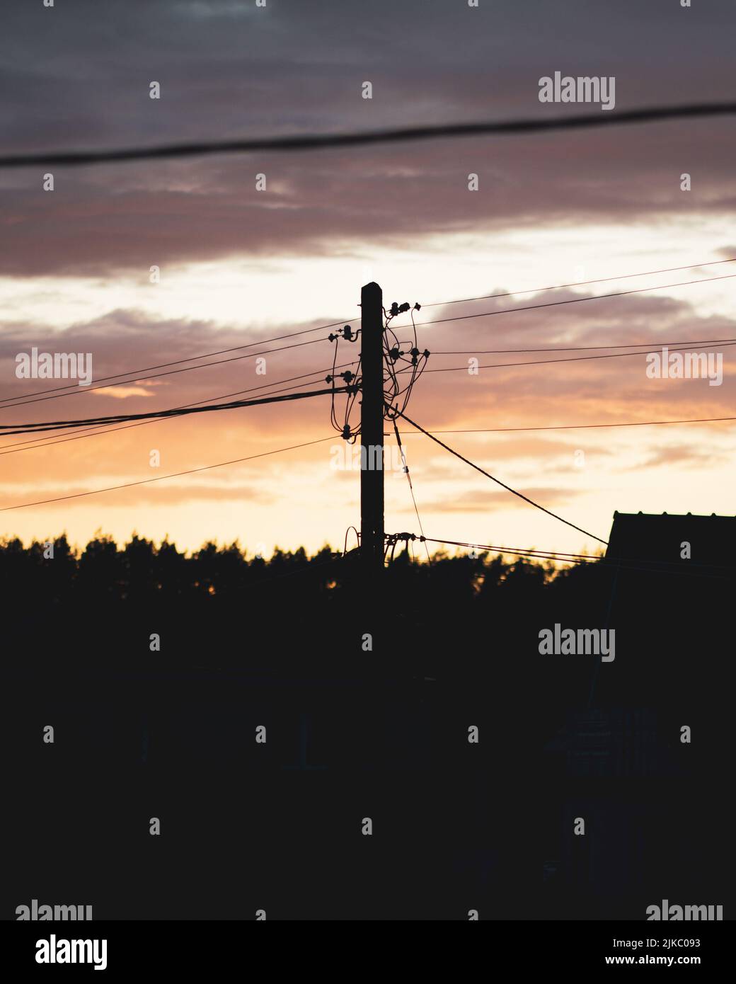 An electric pole with wires against scenic sunset Stock Photo - Alamy