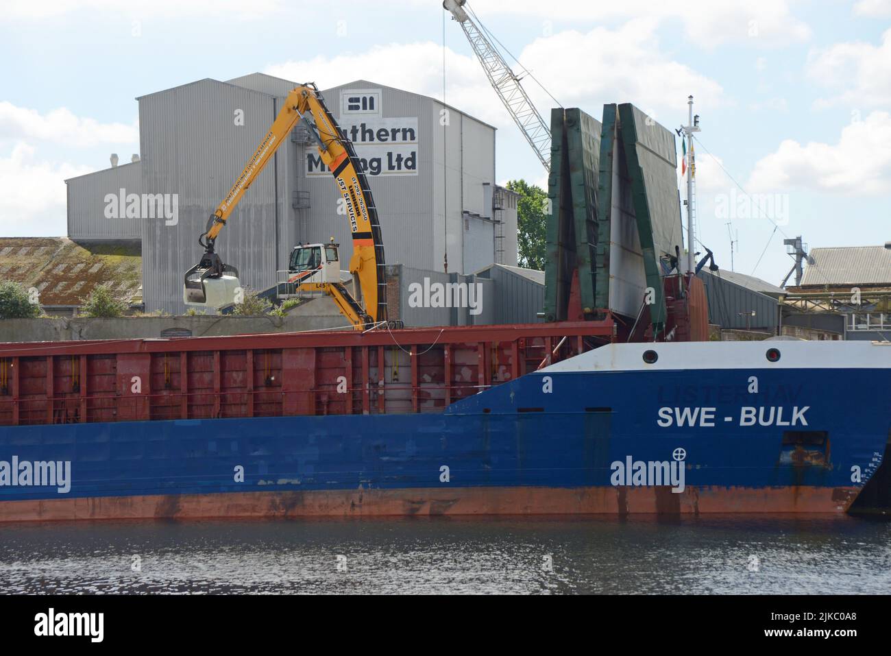 The general cargo ship SWE-BULK loading cargo at the dockside in the Port of Cork, Cork, Ireland ...