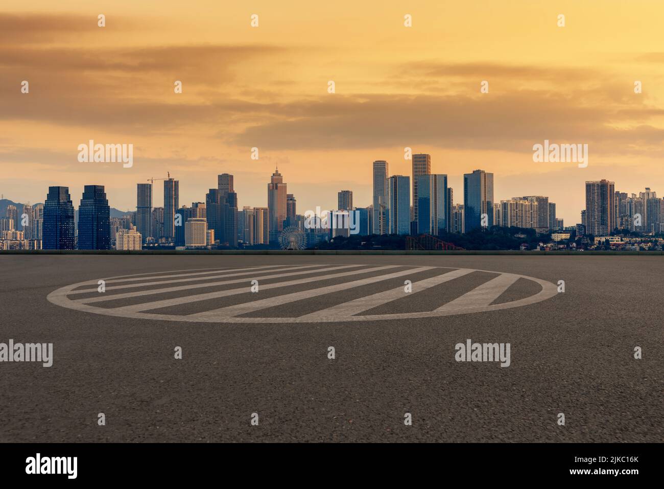 A helicopter parking area with the cityscape background at sunset Stock ...