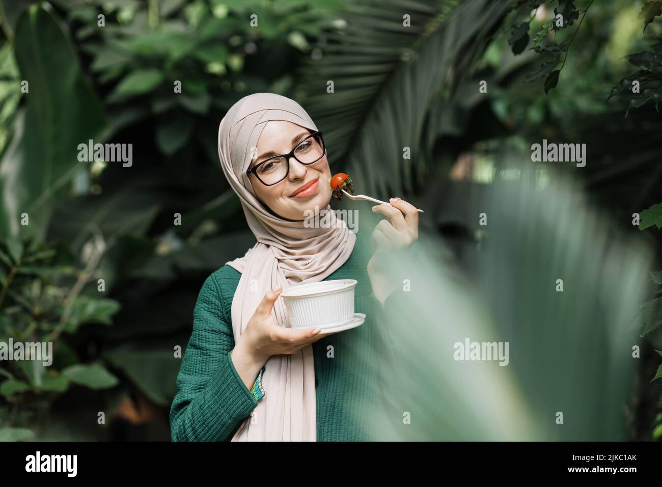 Portrait of happy muslim smiling woman relaxing in spa resort, eating ...