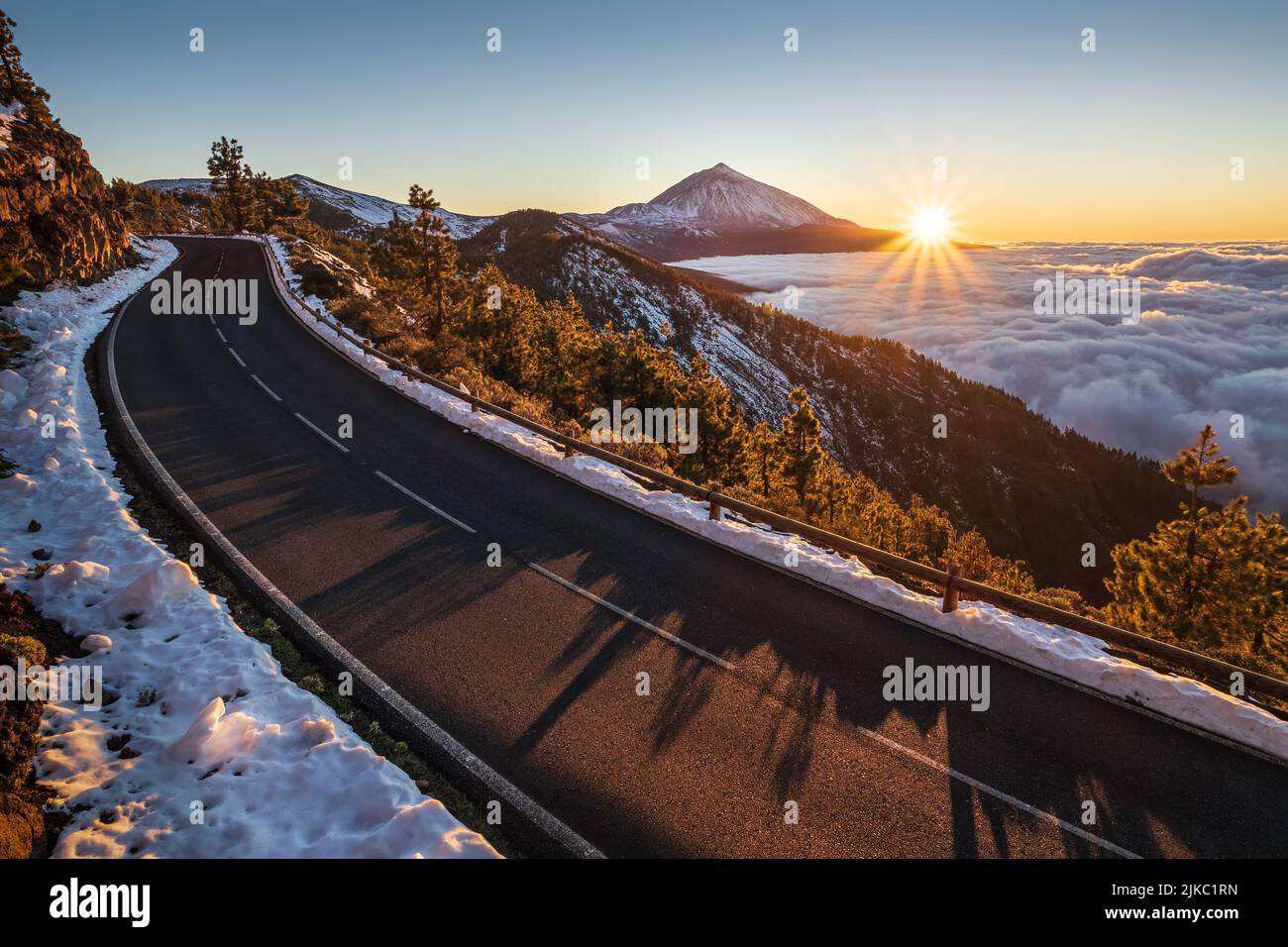 A beautiful view of the road surrounded by snow volcano on the Teide ...