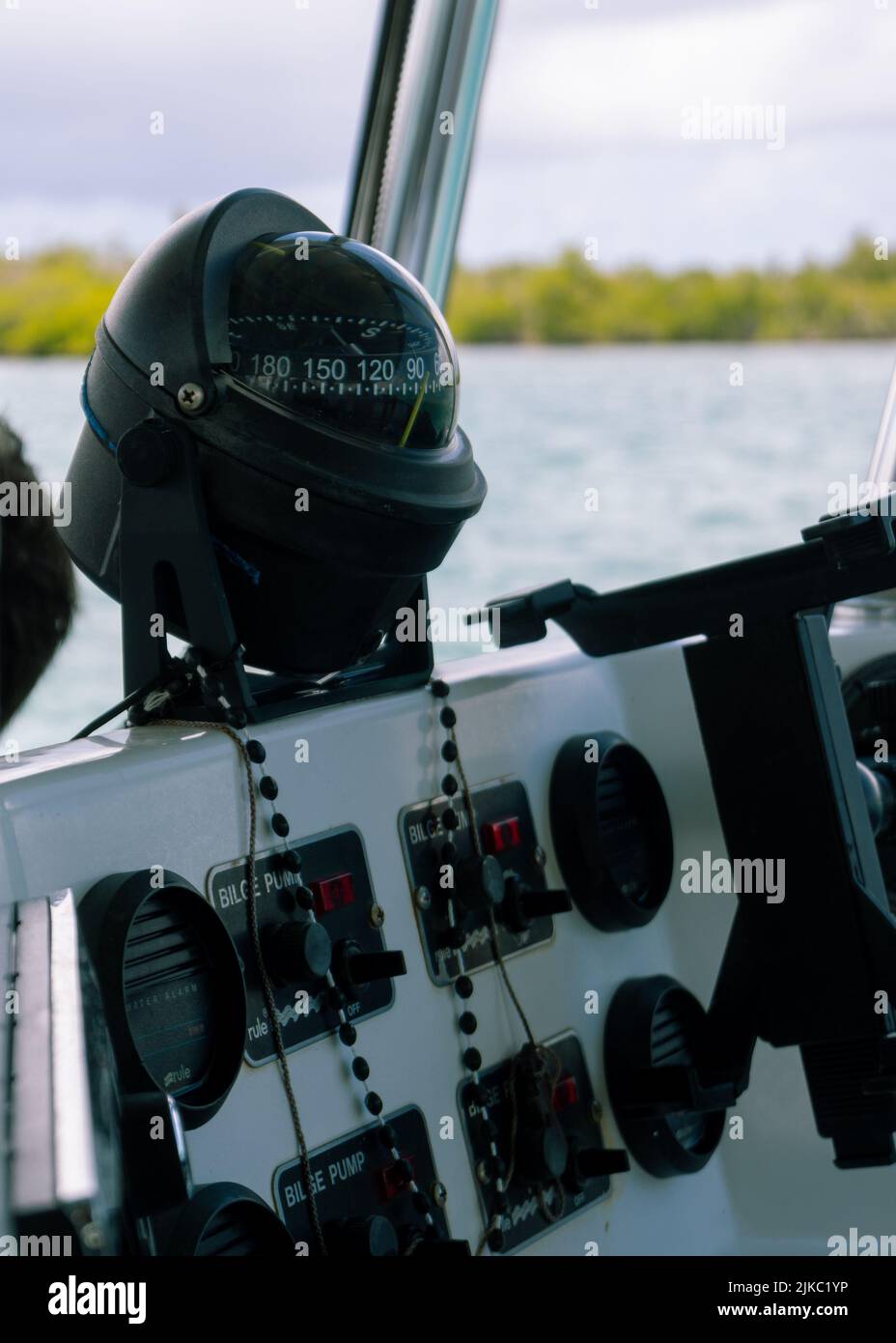 A vertical closeup shot of a boat control panel with a compass Stock ...
