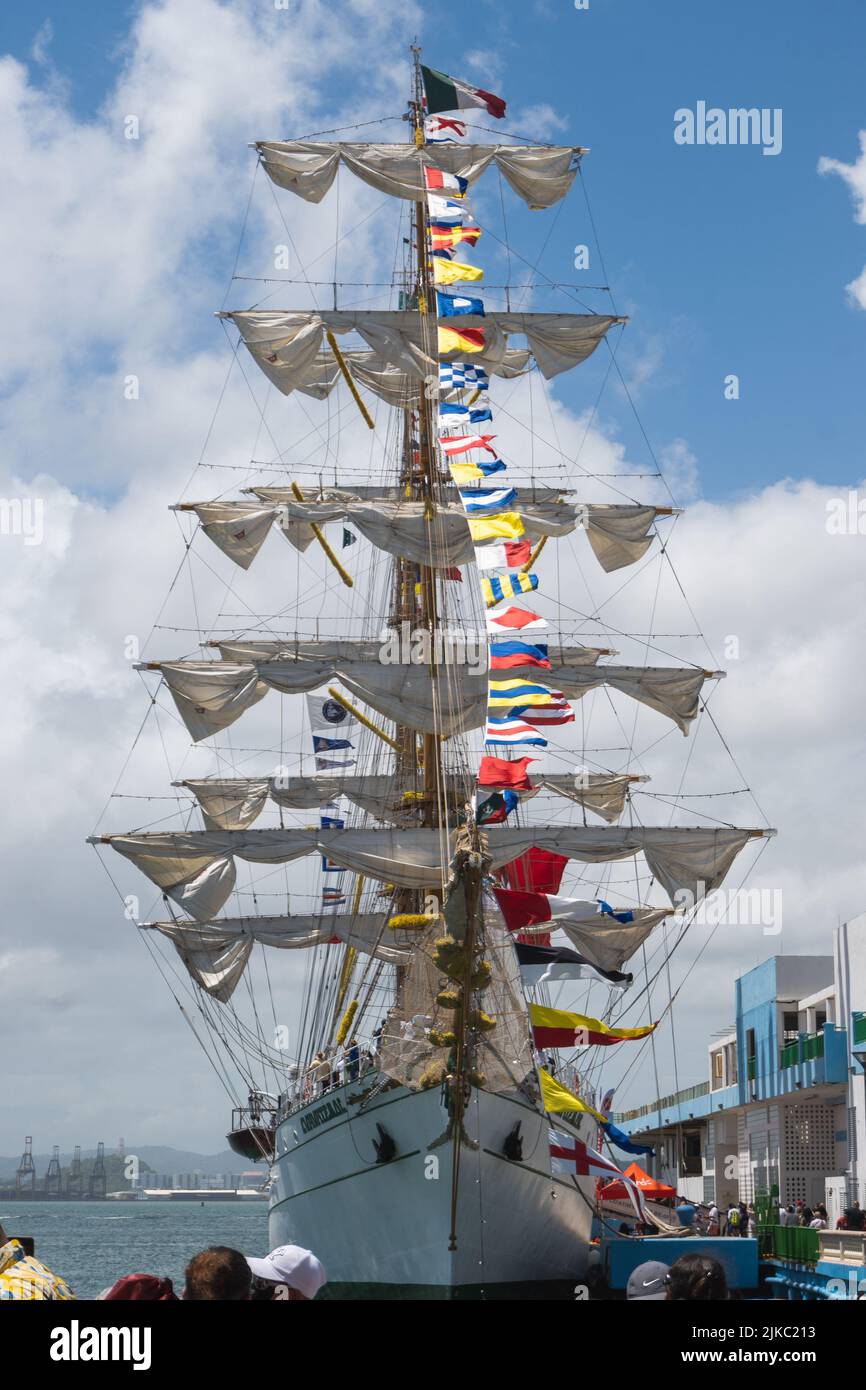 A vertical shot of a regatta sailboat decorated with international ...